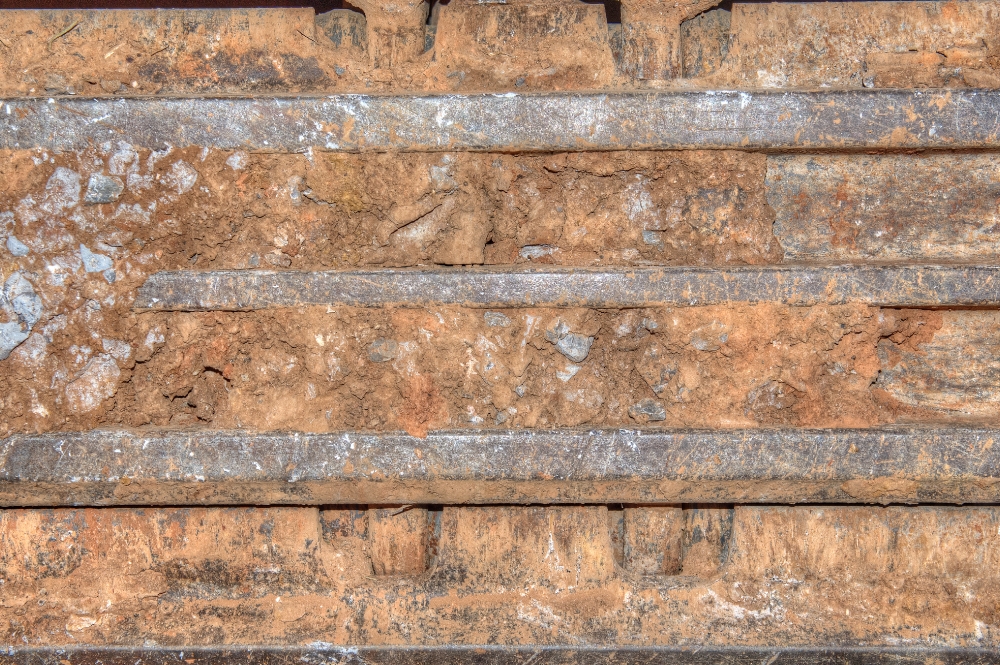 Excavator Heavy construction equipment closeup tracks with dirt ...