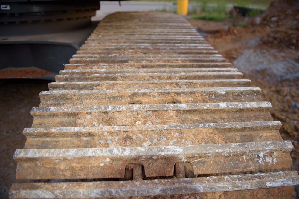 Excavator Heavy construction equipment closeup tracks with dirt ...