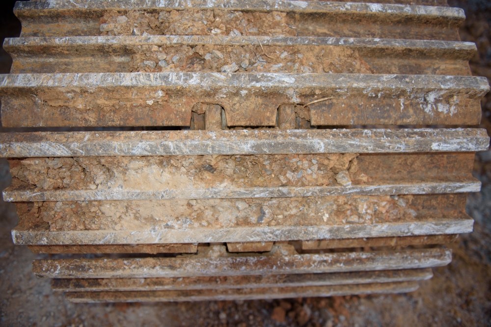 Excavator Heavy construction equipment closeup tracks with dirt ...