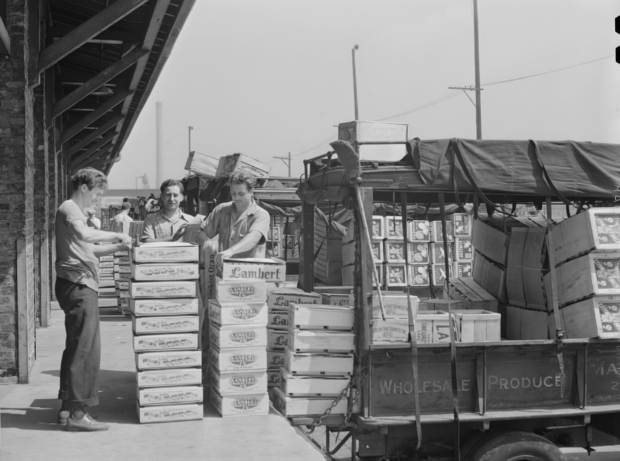 Loading crates of fruits into truck at fruit terminal. Chicago I ...